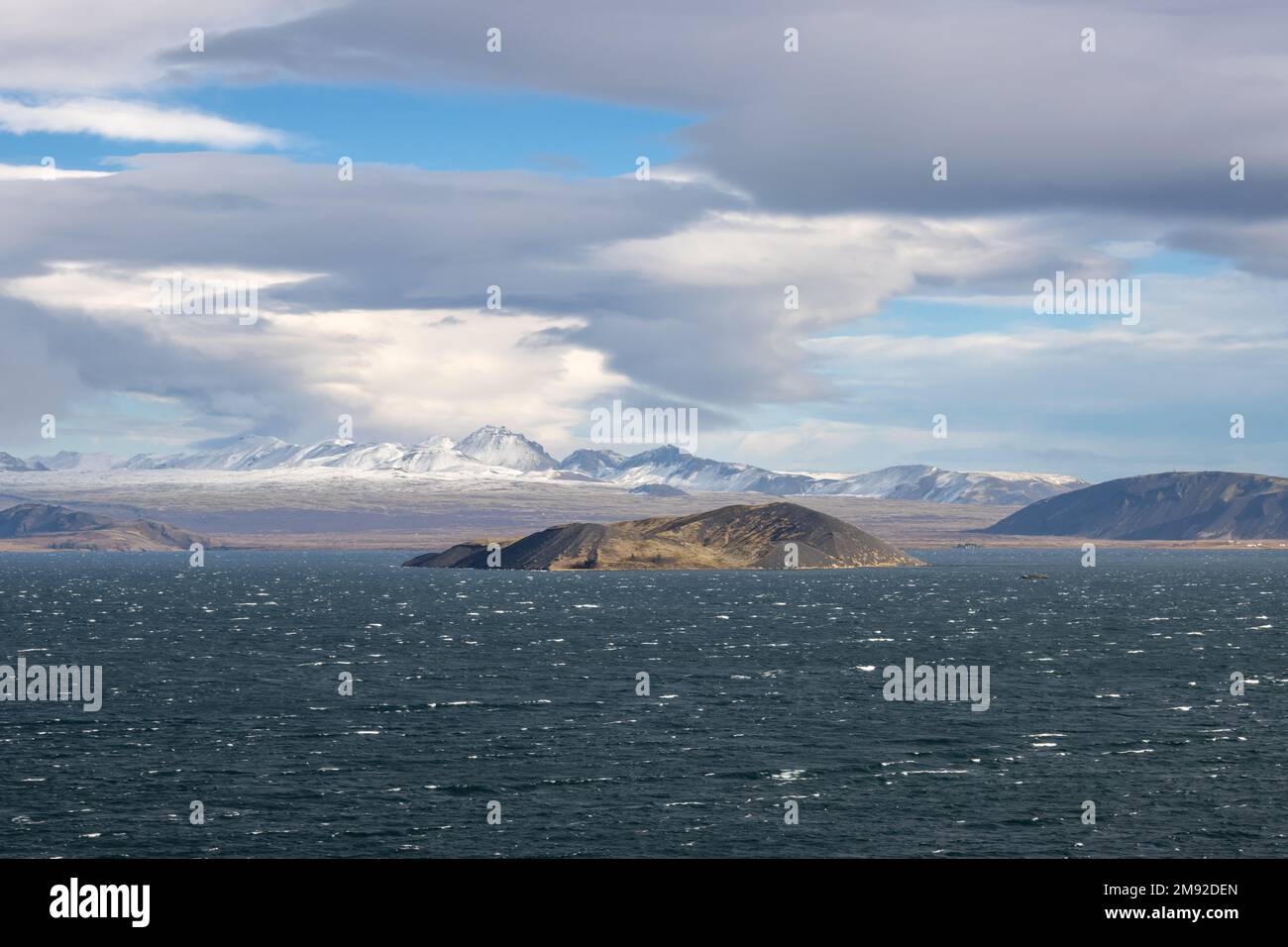 Calm water of the famous big lake Thingvallavatn. Mountains covered by ...