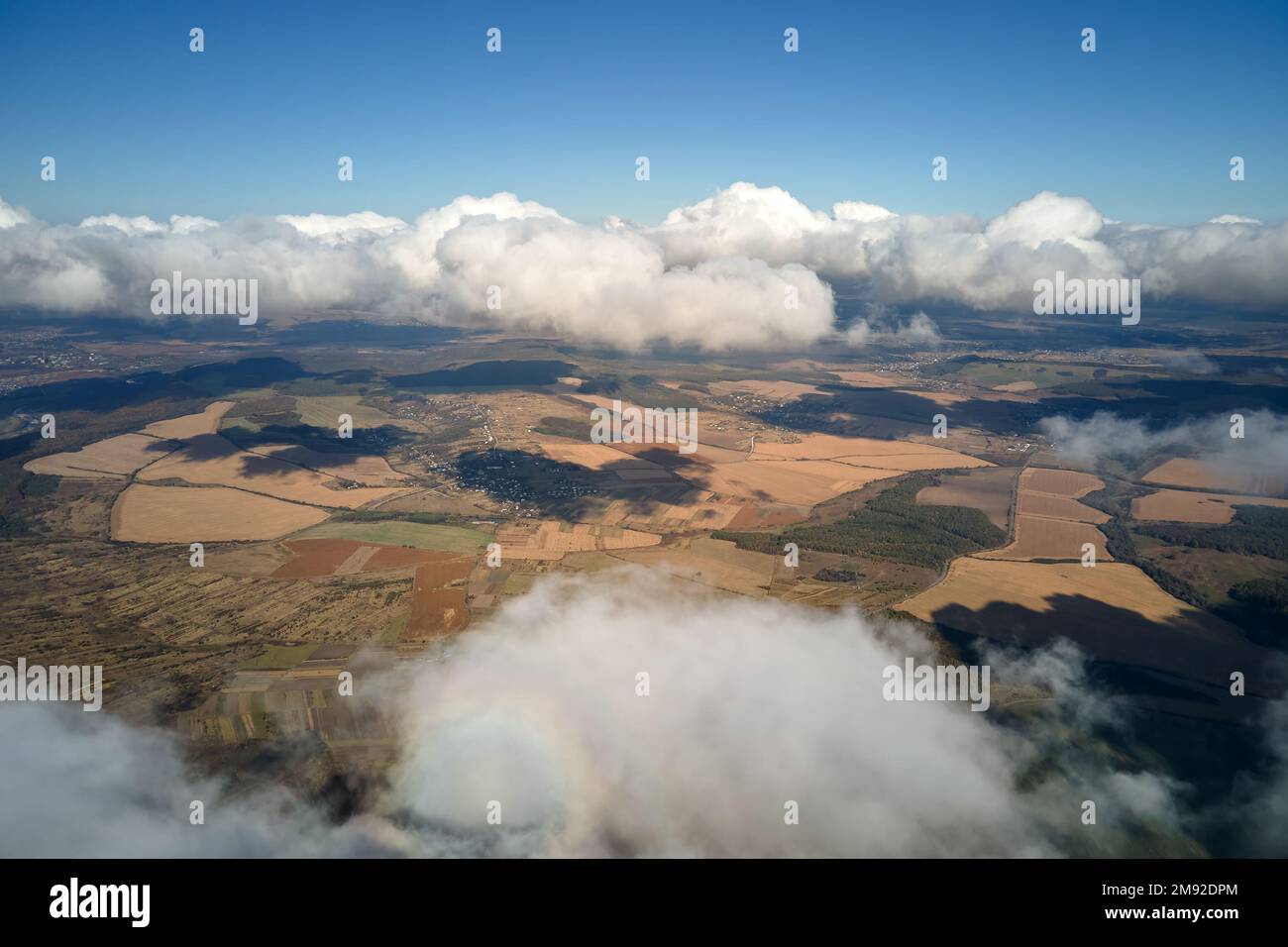 Aerial view from airplane window at high altitude of earth covered with ...