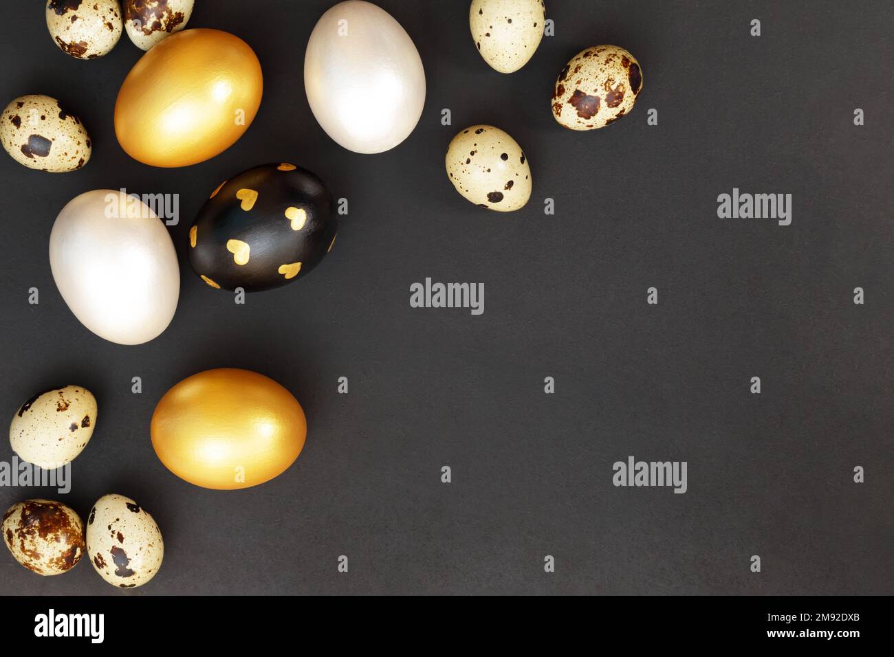 Gold, black and white Easter eggs on a dark gray background Stock Photo ...