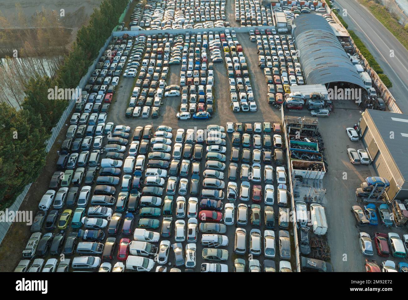 Aerial view of big parking lot of junkyard with rows of discarded ...