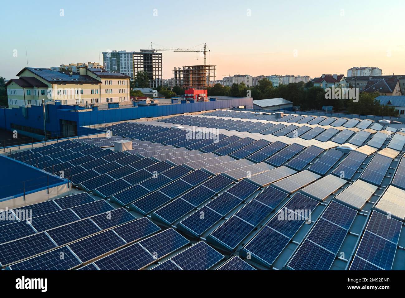 Aerial view of blue photovoltaic solar panels mounted on industrial ...