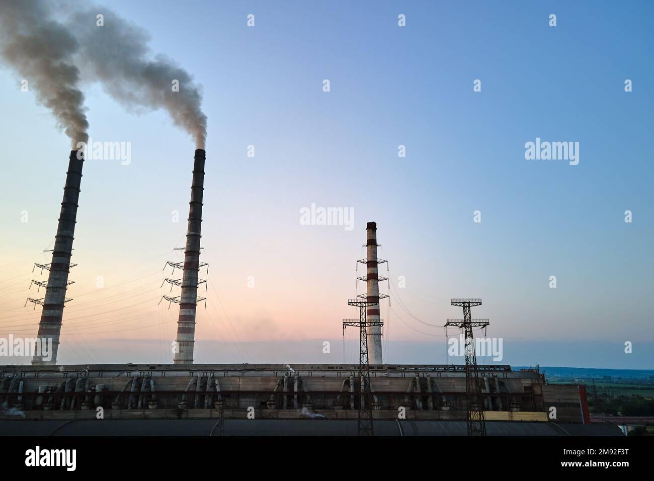Aerial view of coal power plant high pipes with black smokestack ...