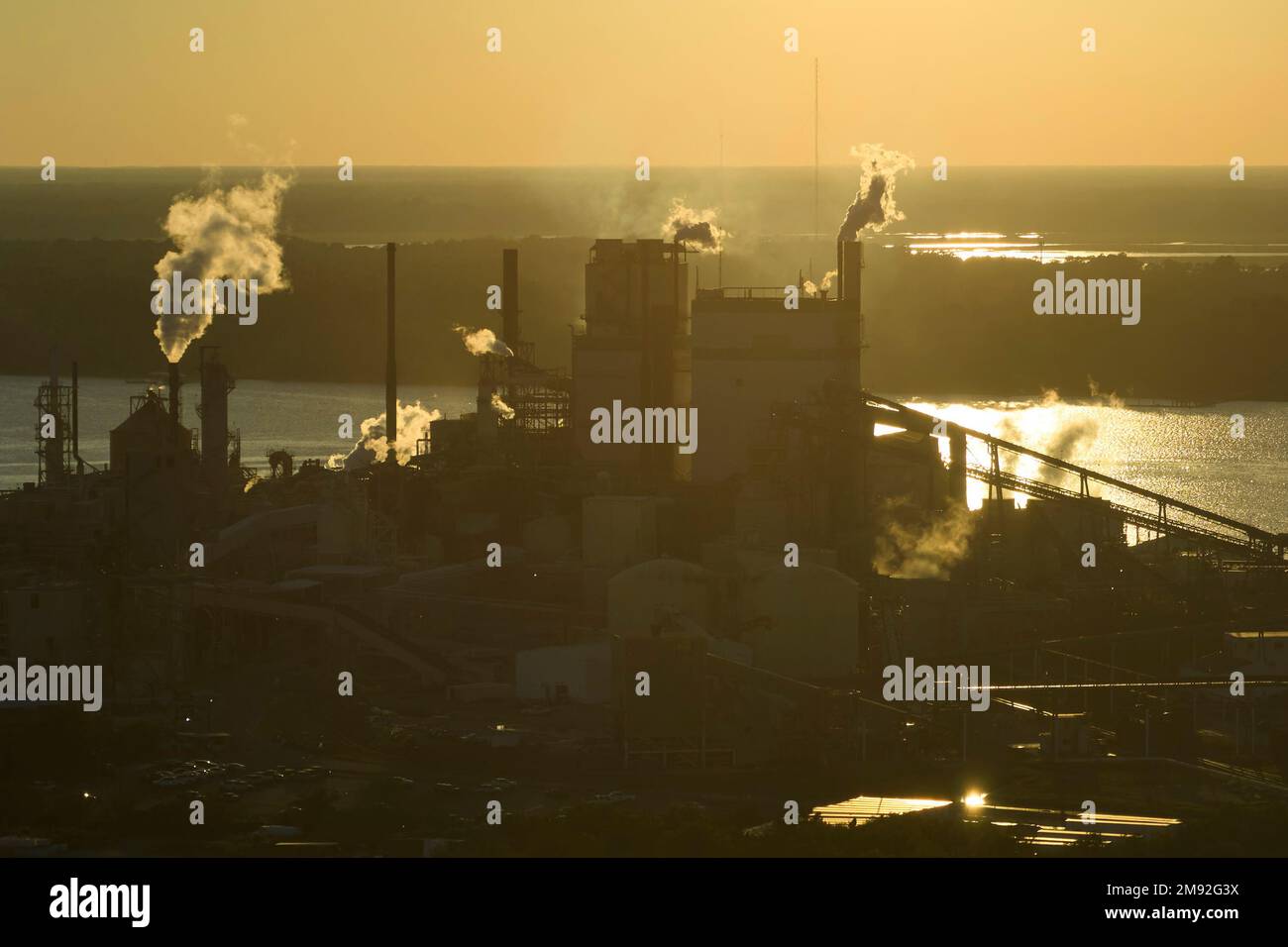 Aerial view of large factory with smokestack from production process ...