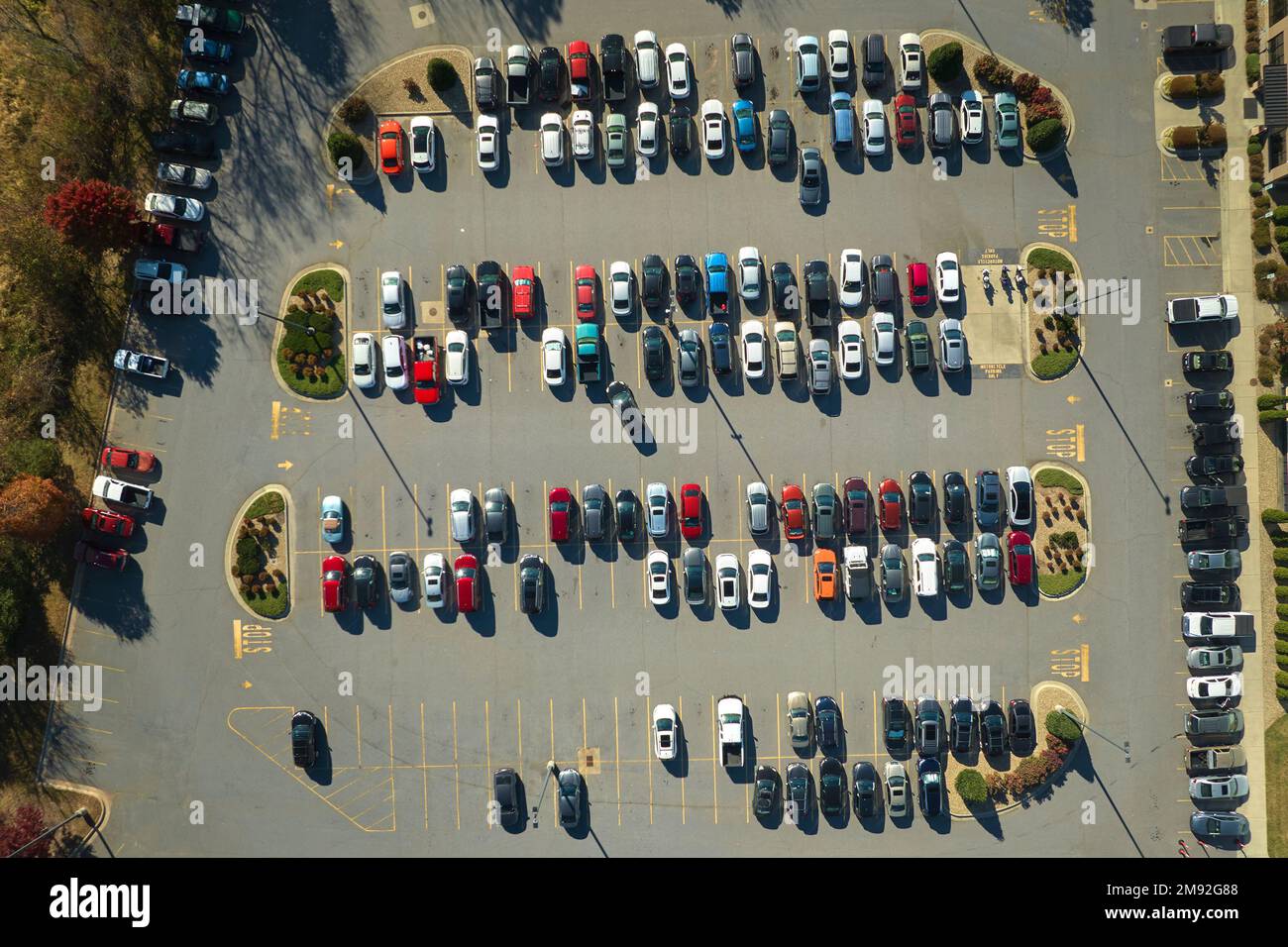 Aerial view of large parking lot with many parked colorful cars ...