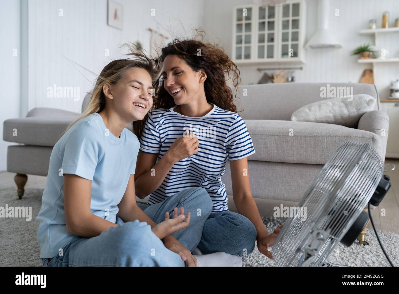 Overjoyed mother and teen daughter enjoying fresh cold air from ...