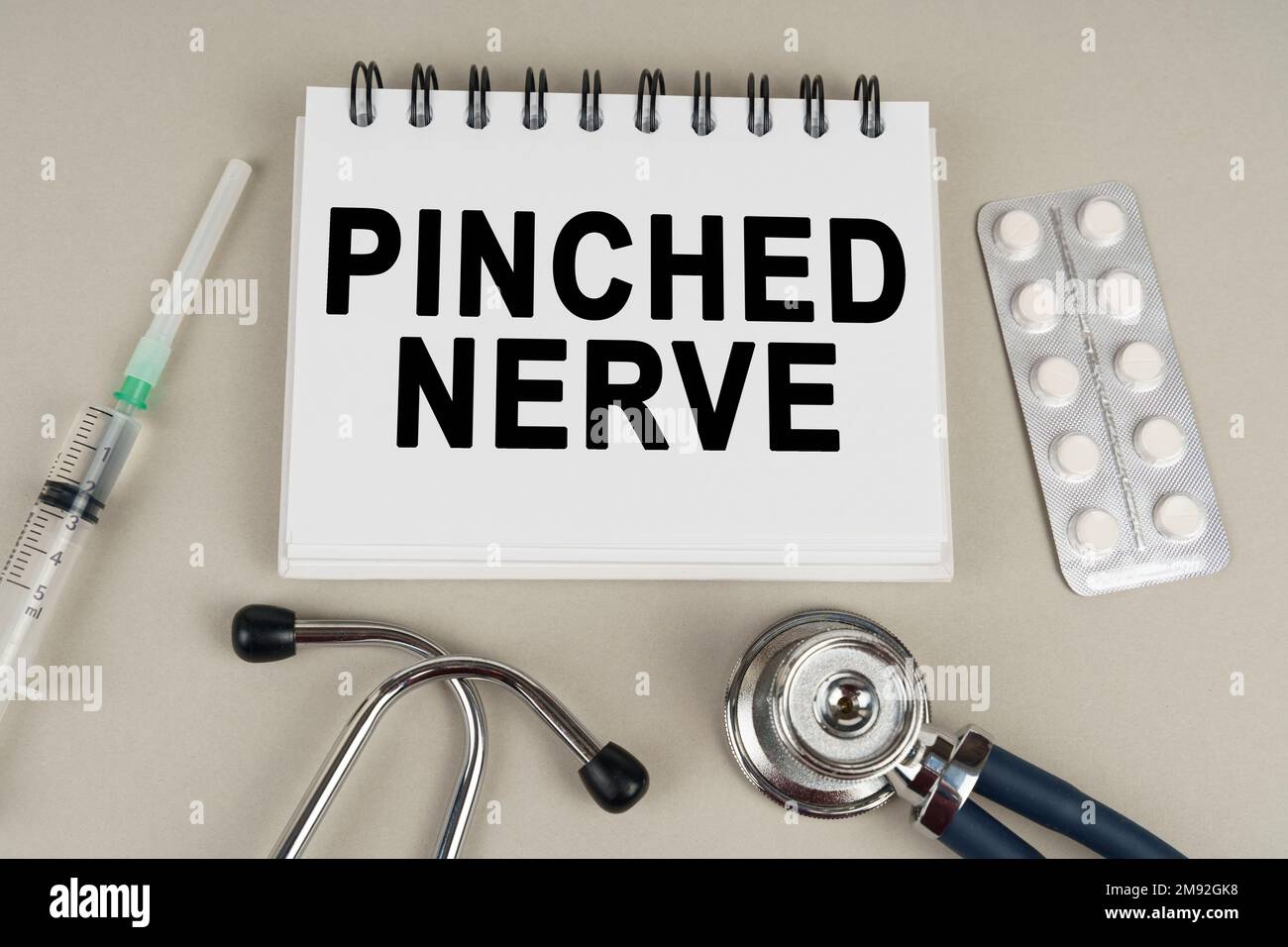 Medical concept. On a gray surface, a syringe, a thermometer, a ...