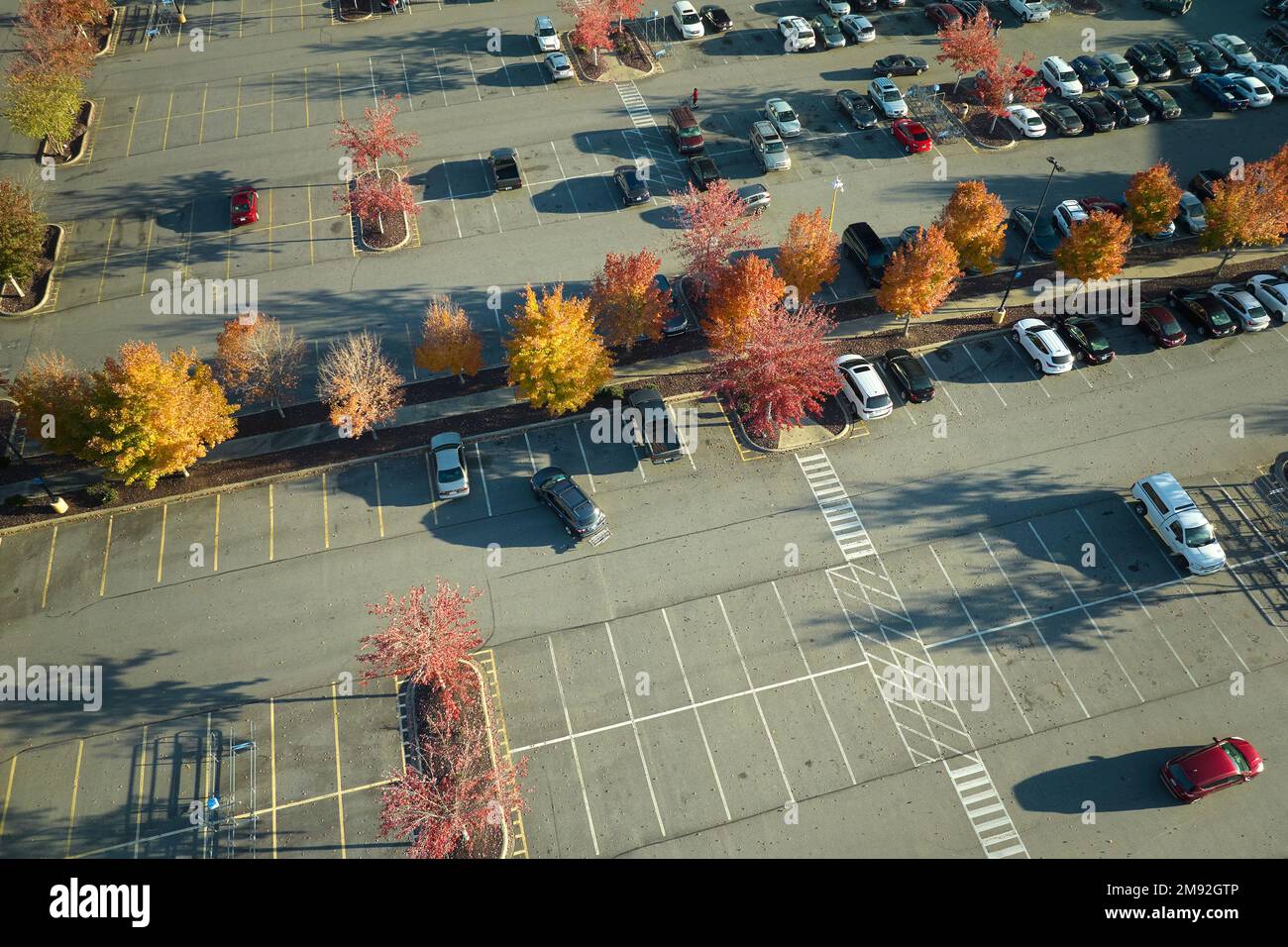 Aerial view of many colorful cars parked on parking lot with lines and ...