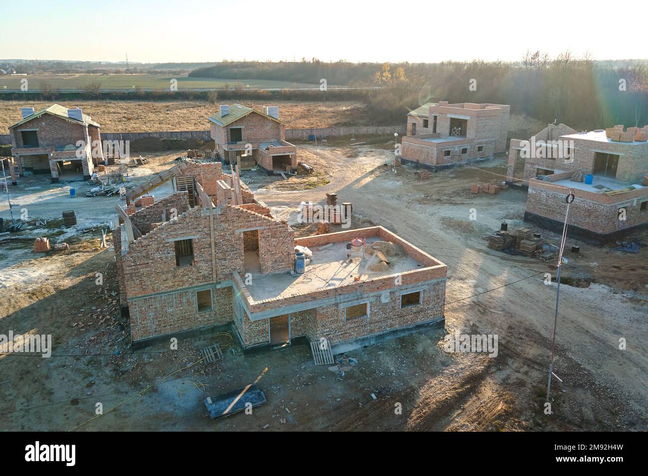 Aerial view of new homes with brick framework walls under construction ...