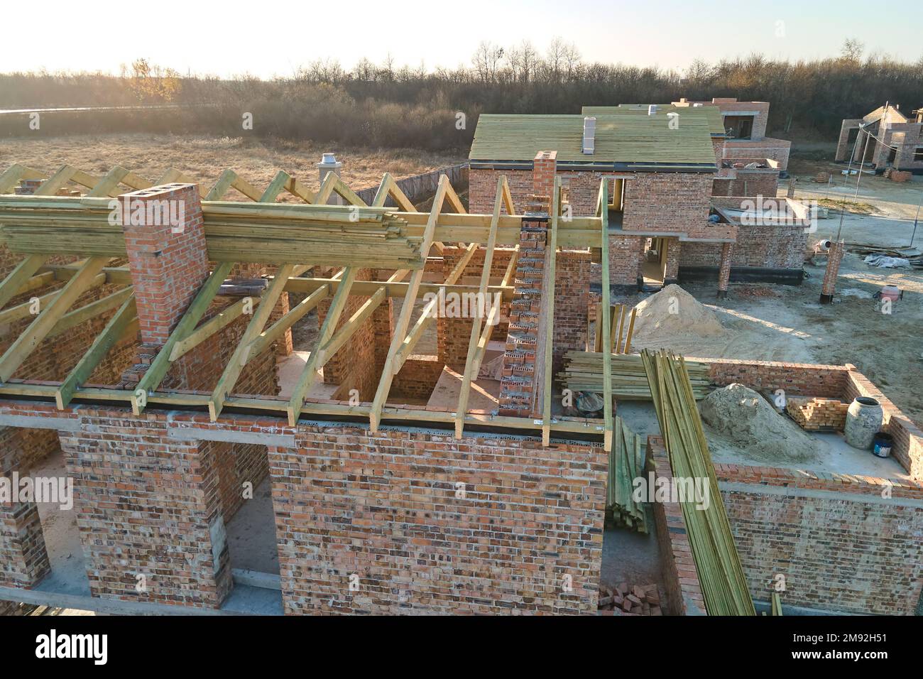 Aerial view of new homes with brick framework walls under construction ...