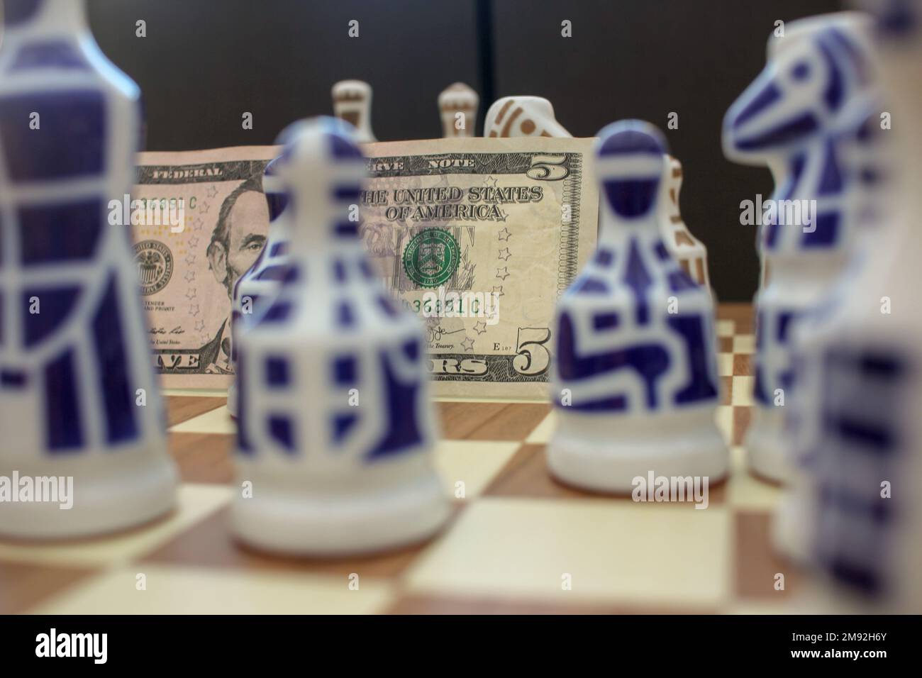 dollar bill on the chessboard among the chess pieces Stock Photo - Alamy