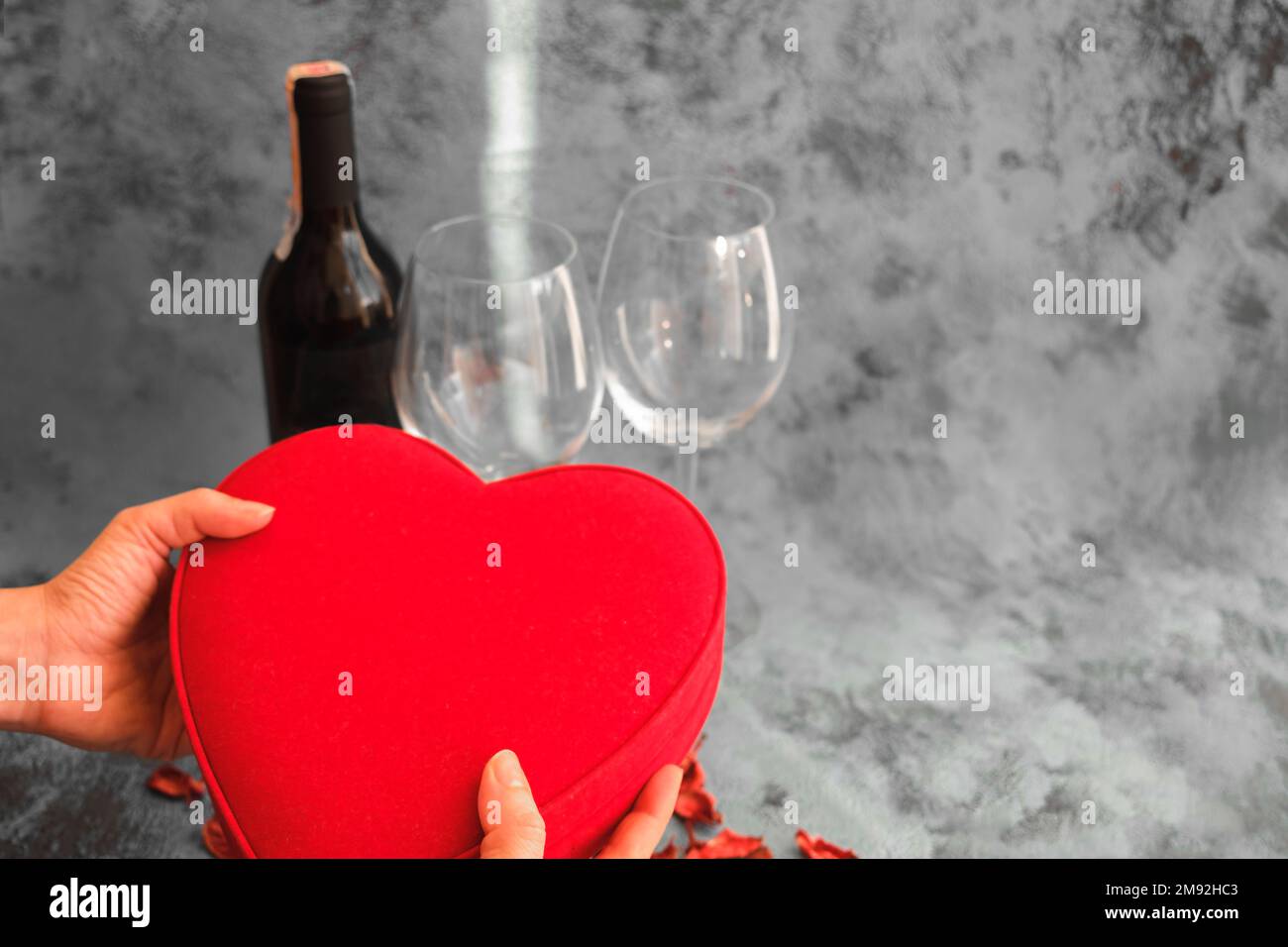 Giving a red heart shaped gift on Valentine`s Day Stock Photo - Alamy