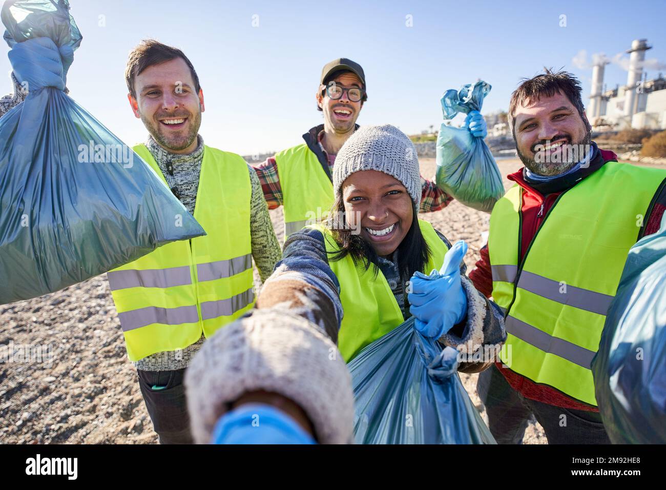 Selfie Group of cleanup volunteers cleaning up waste in nature Stock ...
