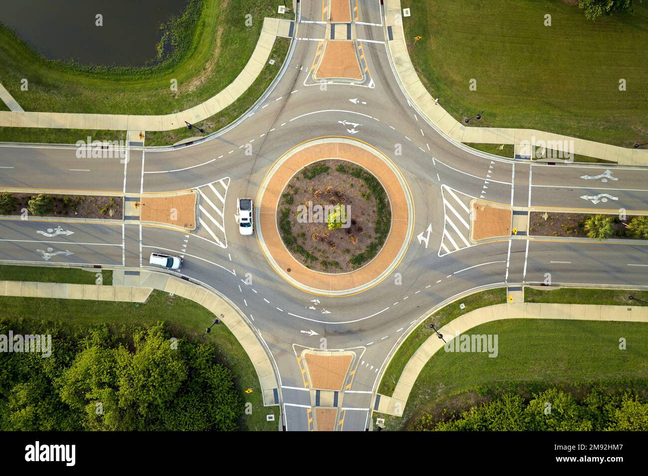 Aerial view of road roundabout intersection with moving cars traffic ...