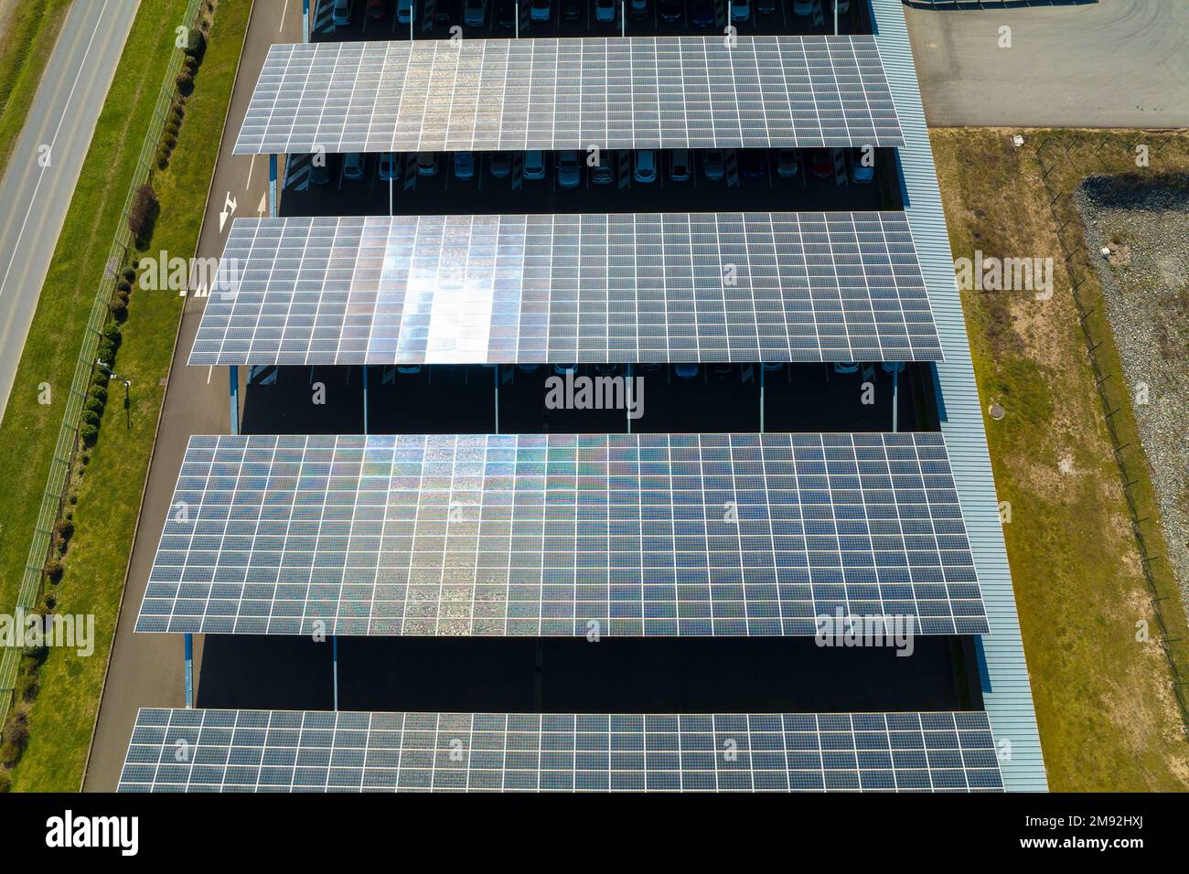Aerial view of solar panels installed over parking lot with parked cars ...