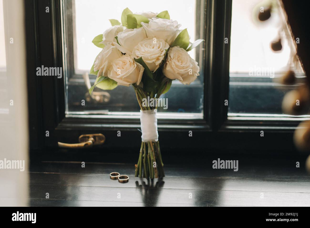 The bride's wedding bouquet of fresh pink flowers and wedding rings ...