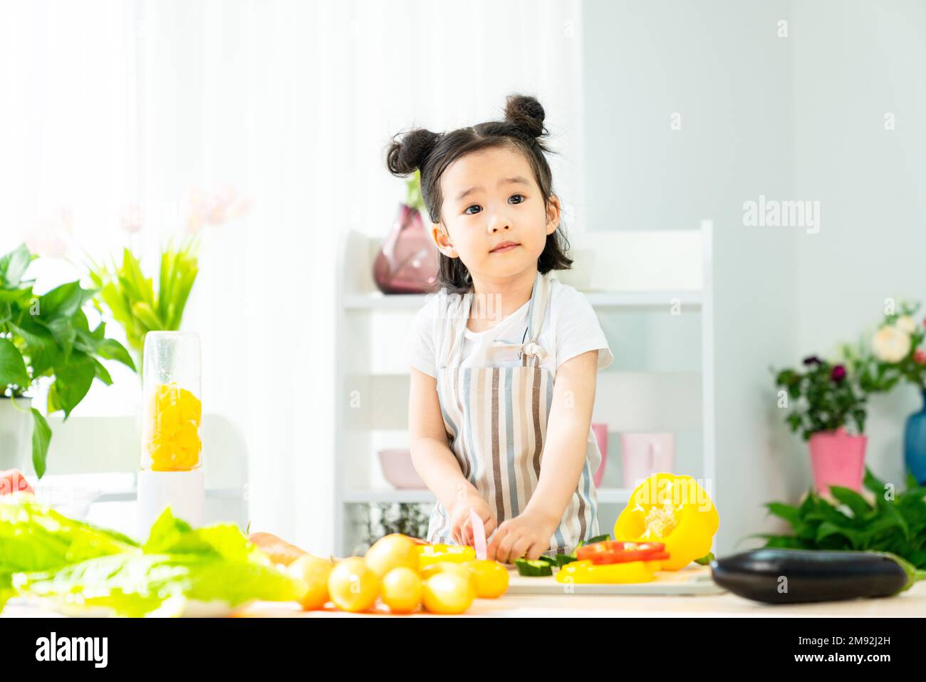 Happy little girl cooking at home Stock Photo - Alamy