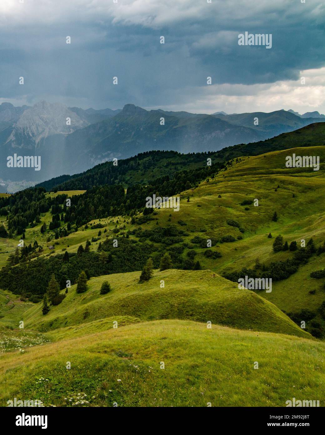 Beautiful alpine landscape with mountains and green meadows and a ...