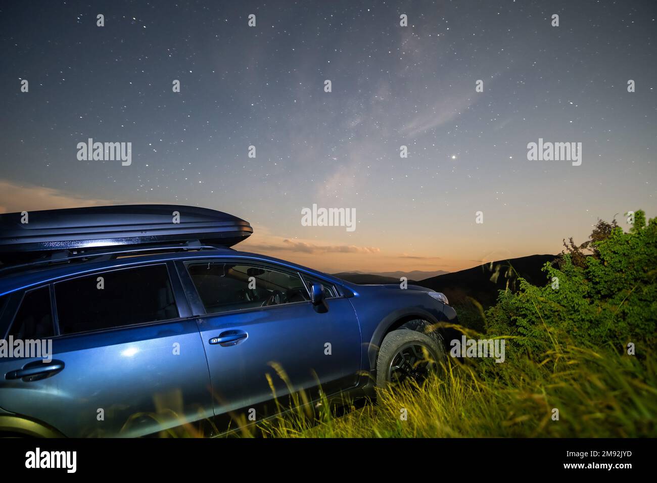 Blue offroad SUV car with roof trunk on background of very beautiful ...