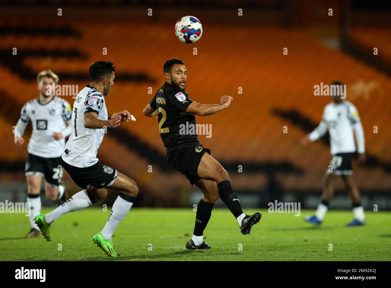 Nathan Thompson of Peterborough United chips the ball over Malvind ...