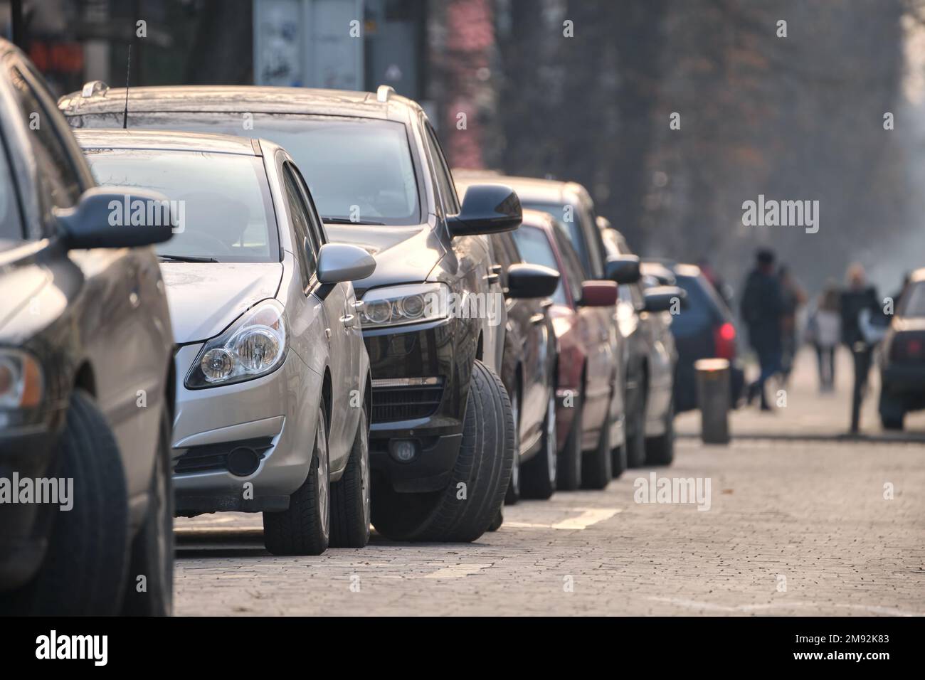 City traffic with cars parked in line on street side Stock Photo - Alamy