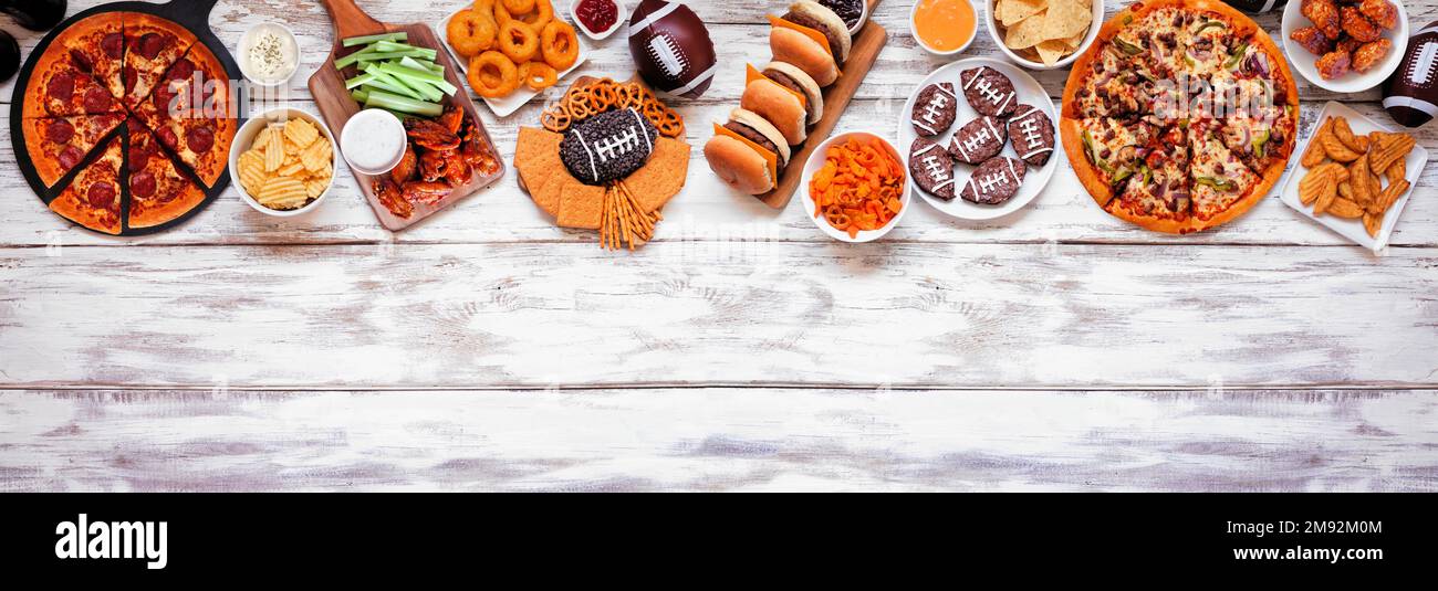 Super Bowl or football theme food top border. Pizza, hamburgers, wings ...