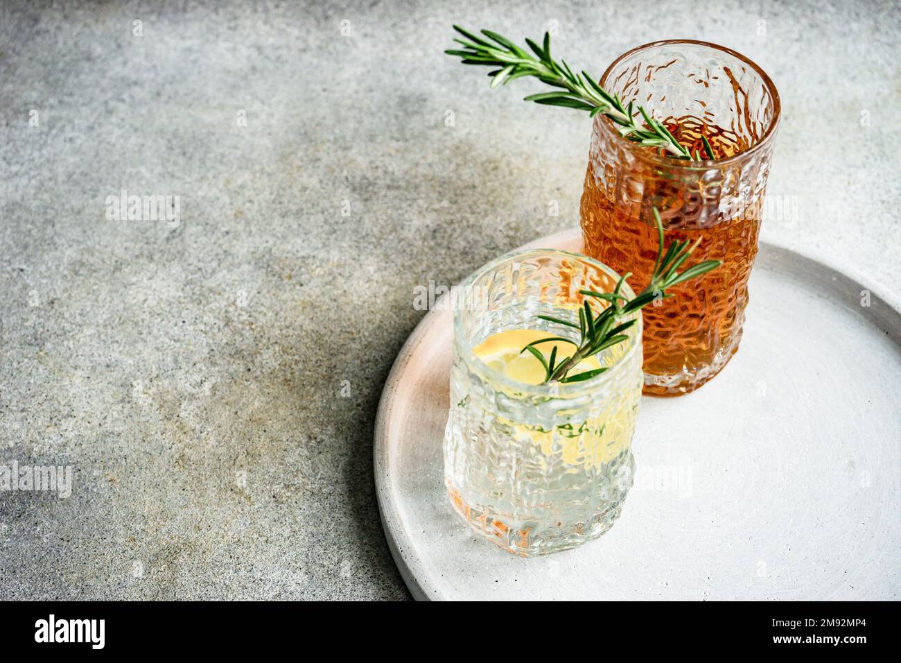 From above alcoholic cocktails in the crystal glass with fresh rosemary ...