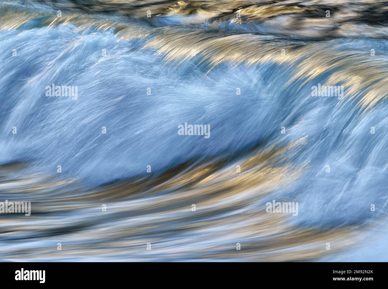 Abstract background of fast stream of water splashing in blue sea with ...