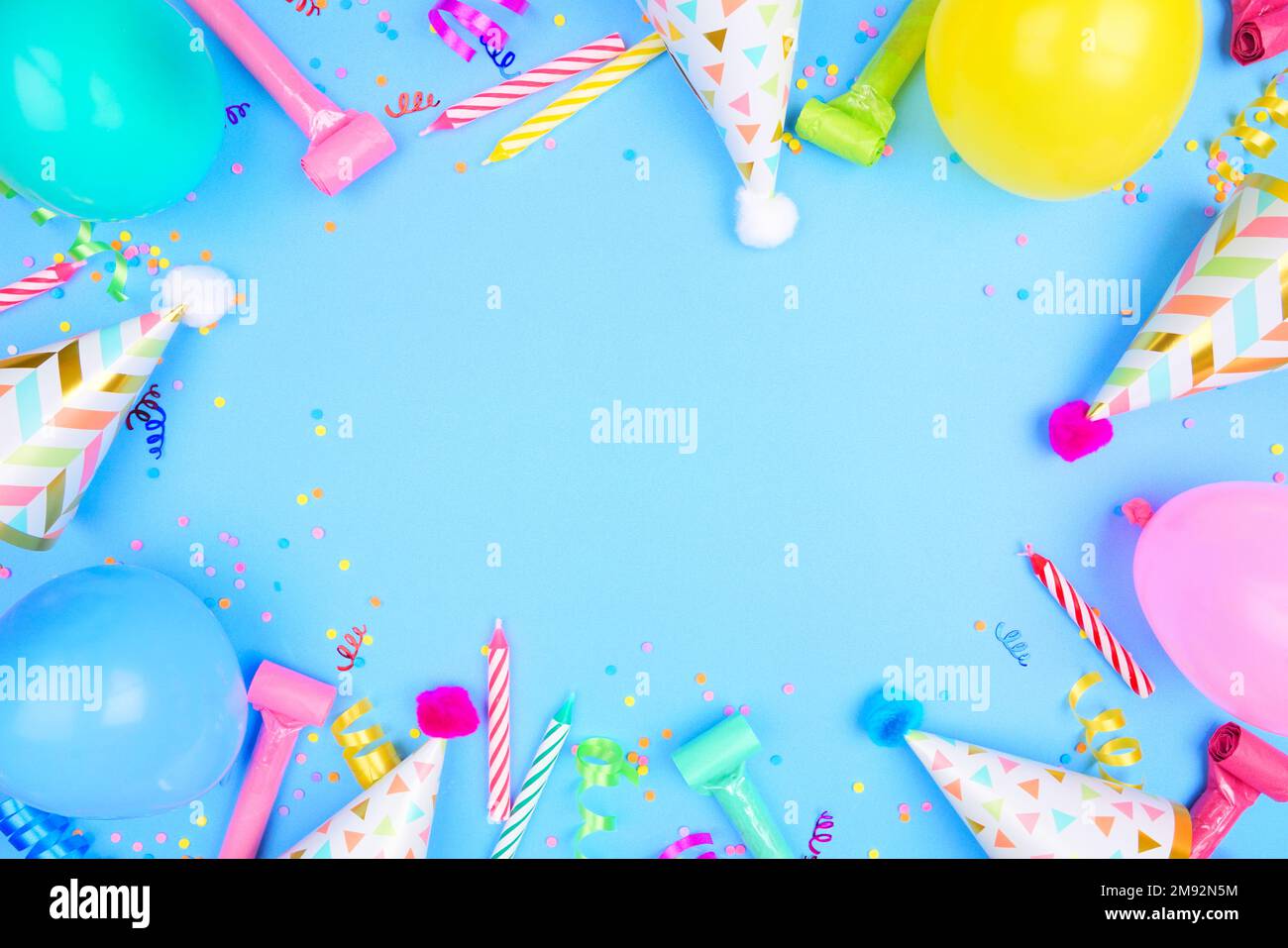 Birthday party frame on a blue background. Top view with confetti ...