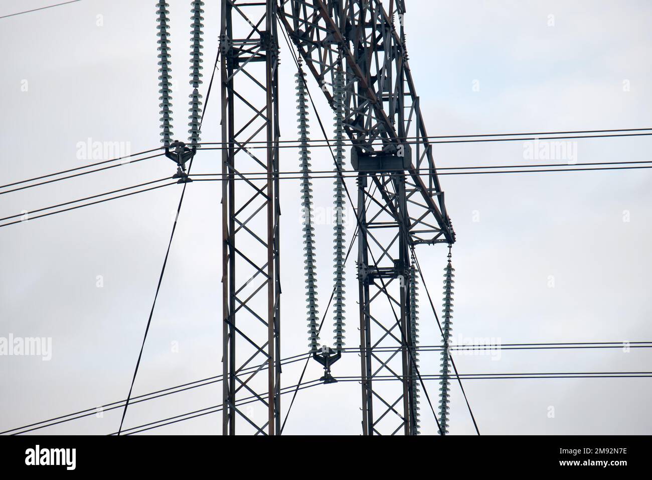 High voltage tower with electric power lines divided by safe guard ...