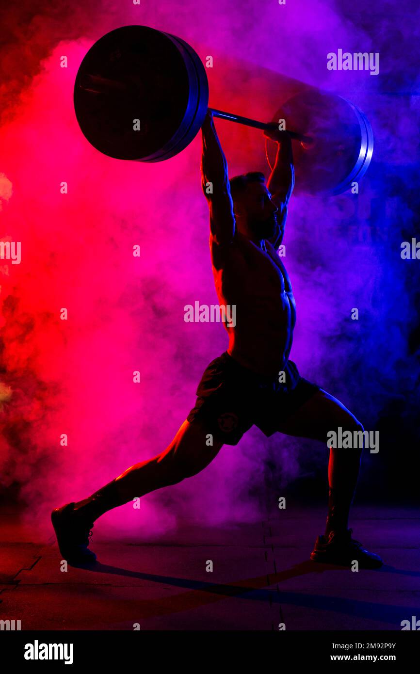 Full body side view of powerful unrecognizable male athlete lifting ...