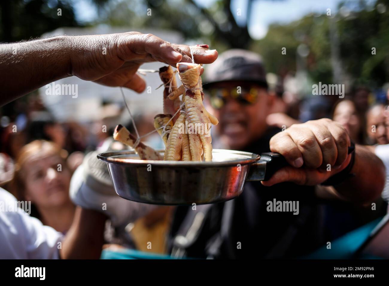 Caracas, Venezuela. 15th Jan, 2023. A demonstrator puts chicken paws in ...