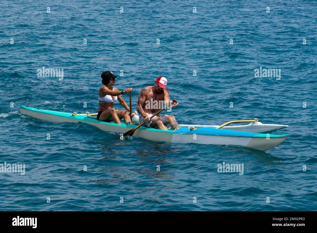 HILOH-BIG ISLAND-HAWAII-22-06-2104. A couple paddle a hawaiian boat in ...