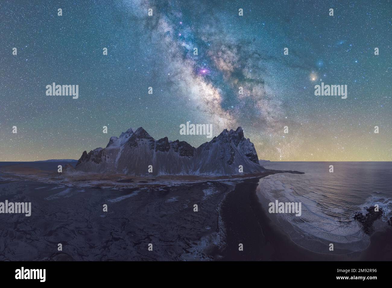 Picturesque glowing stars of Milky Way above frozen sea surrounding ...