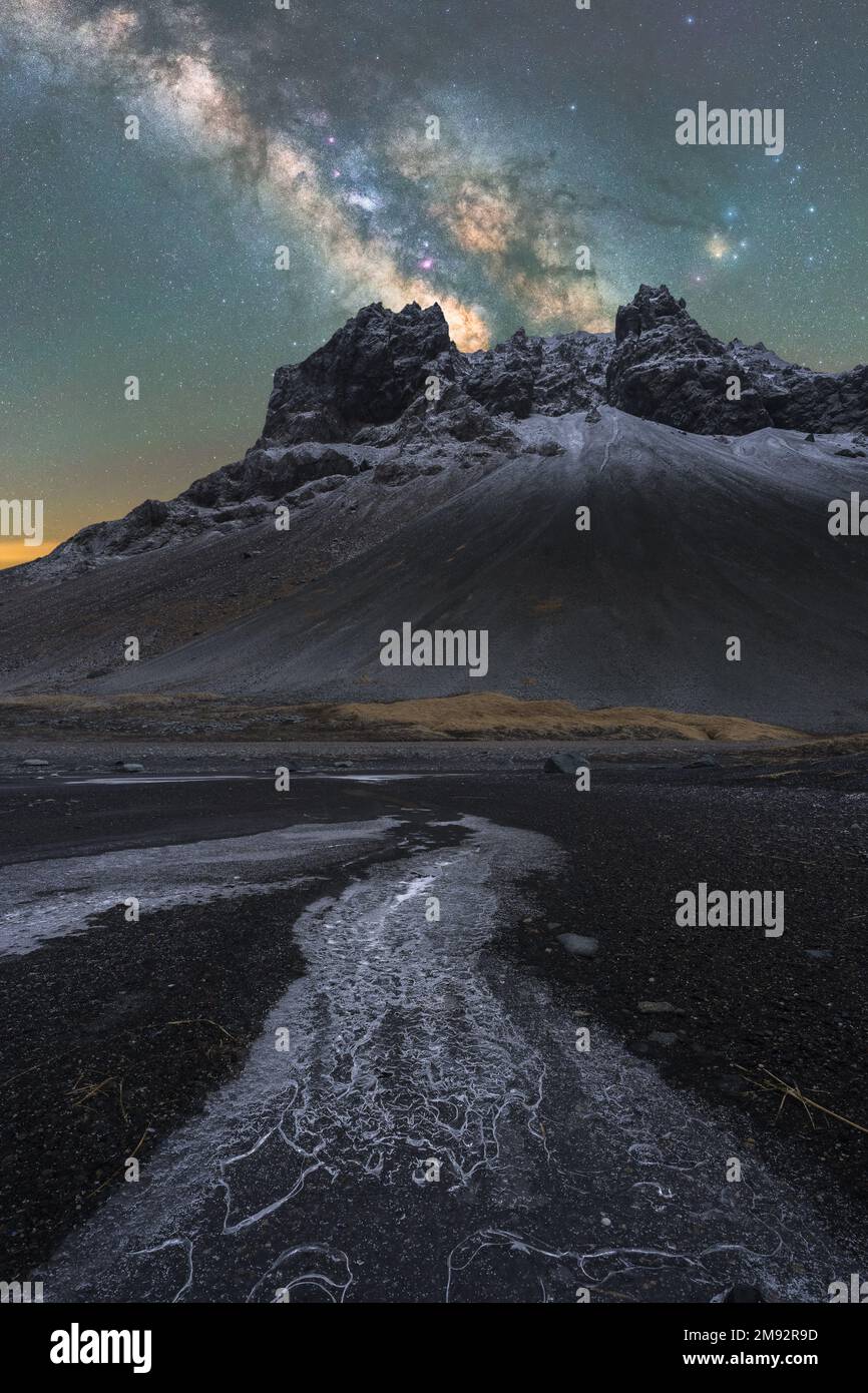 Picturesque glowing stars of Milky Way above frozen sea surrounding ...