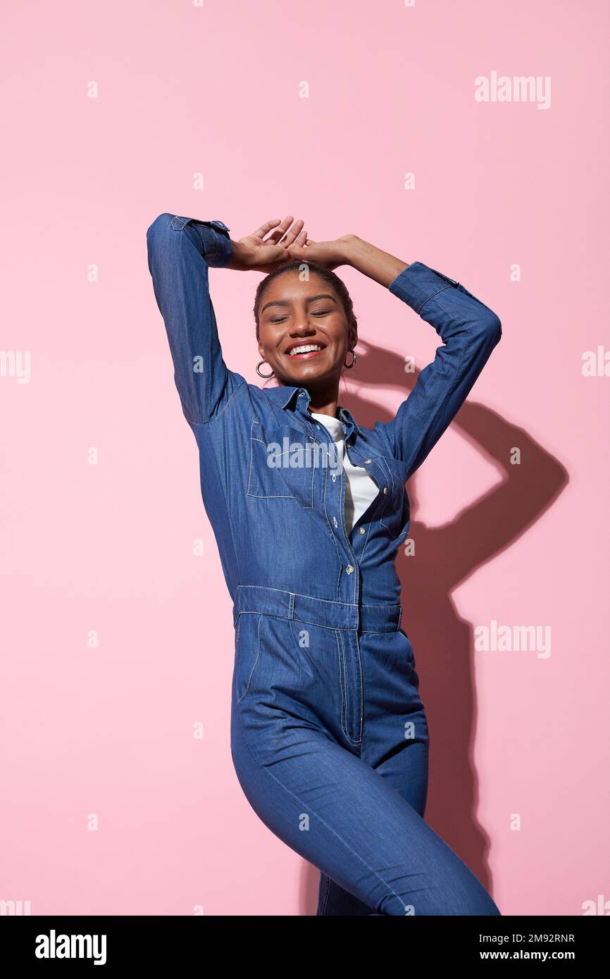 Optimistic young African American female model smiling with eyes ...