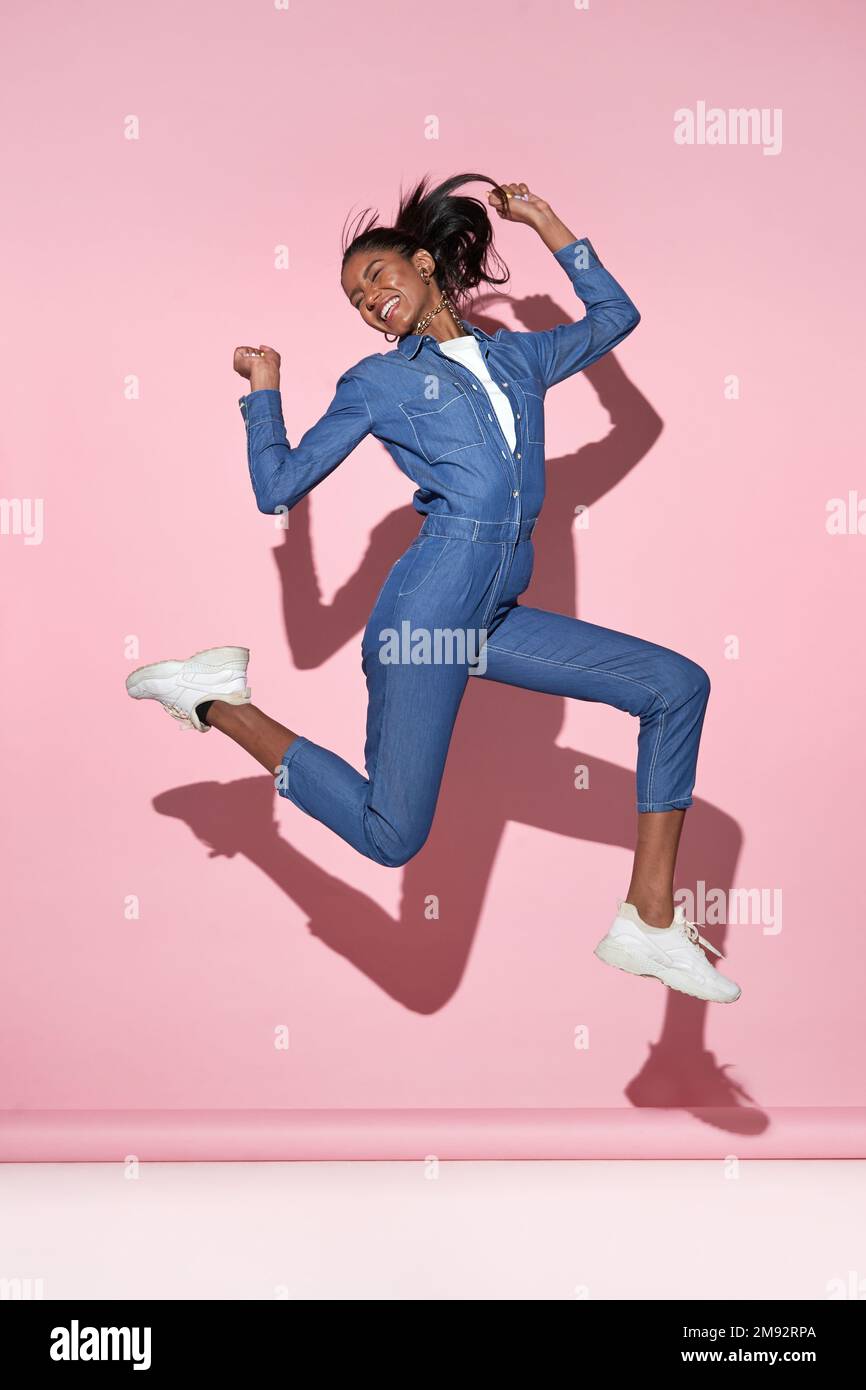 Full body of cheerful young African American female in denim outfit ...