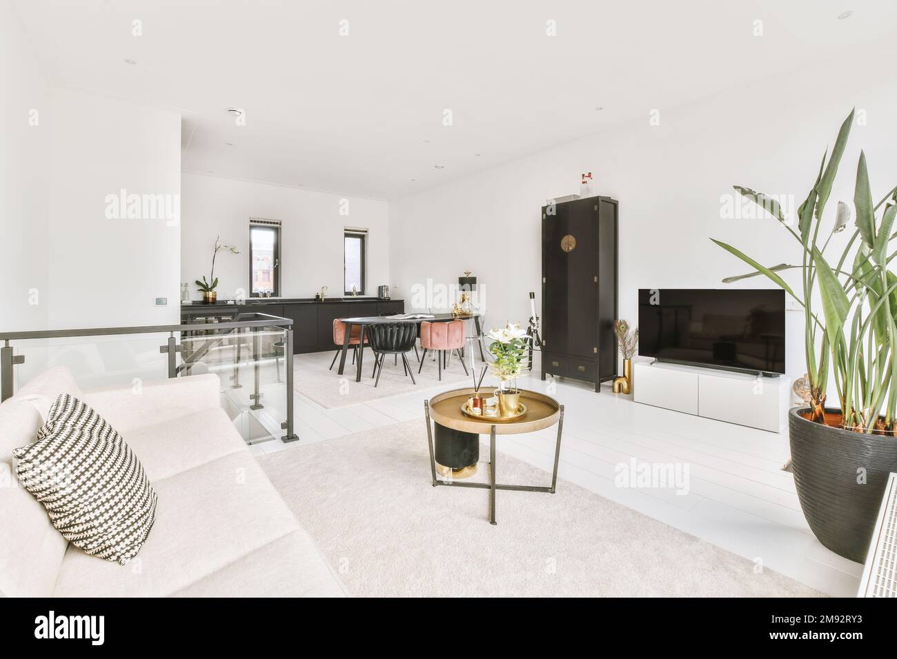 Spacious open plan kitchen with white walls and beautiful living room ...