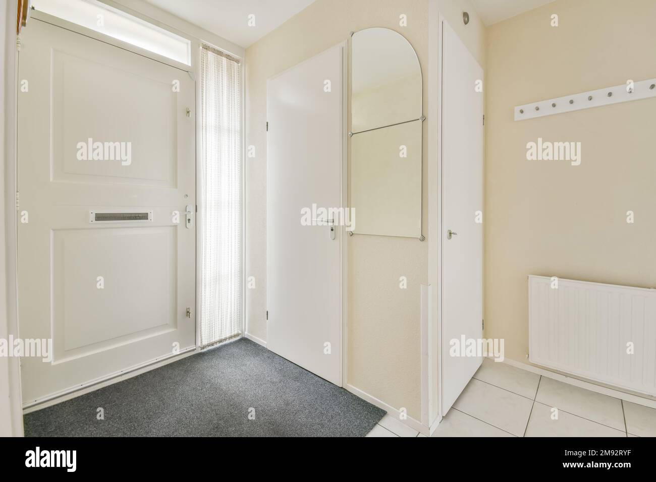 Interior passage way with mirror on wall in modern house Stock Photo ...