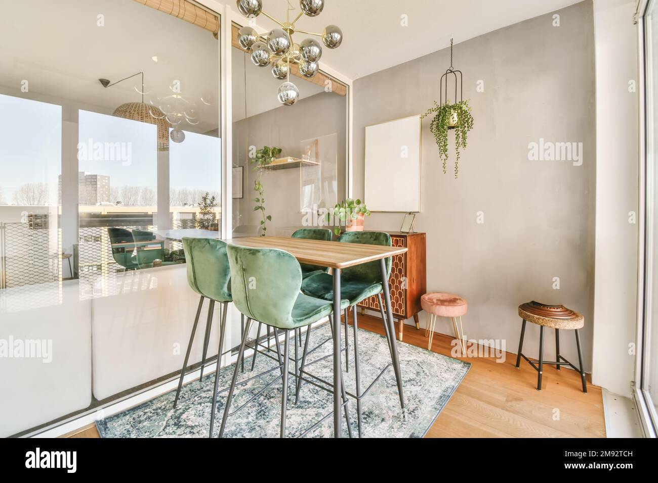 Interior of dining zone with wooden table and chairs placed on rag near ...