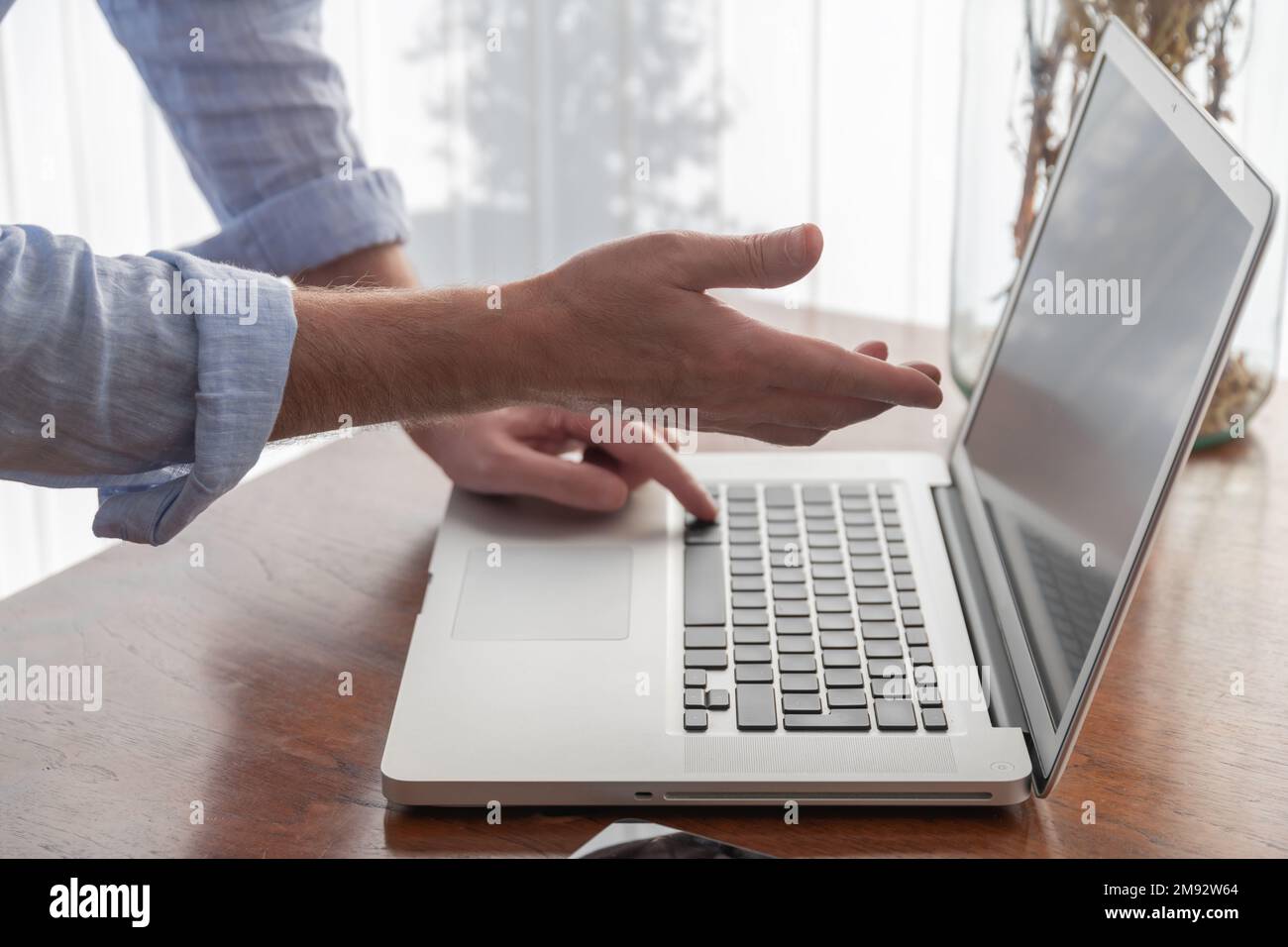 Cropped anonymous male freelancer on table using laptop and working on ...