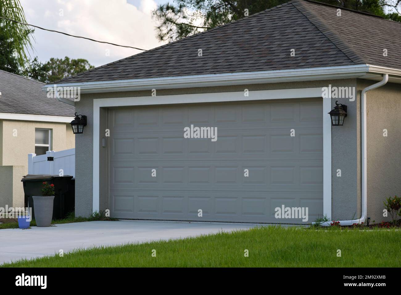 Wide garage double door and concrete driveway of new modern american ...