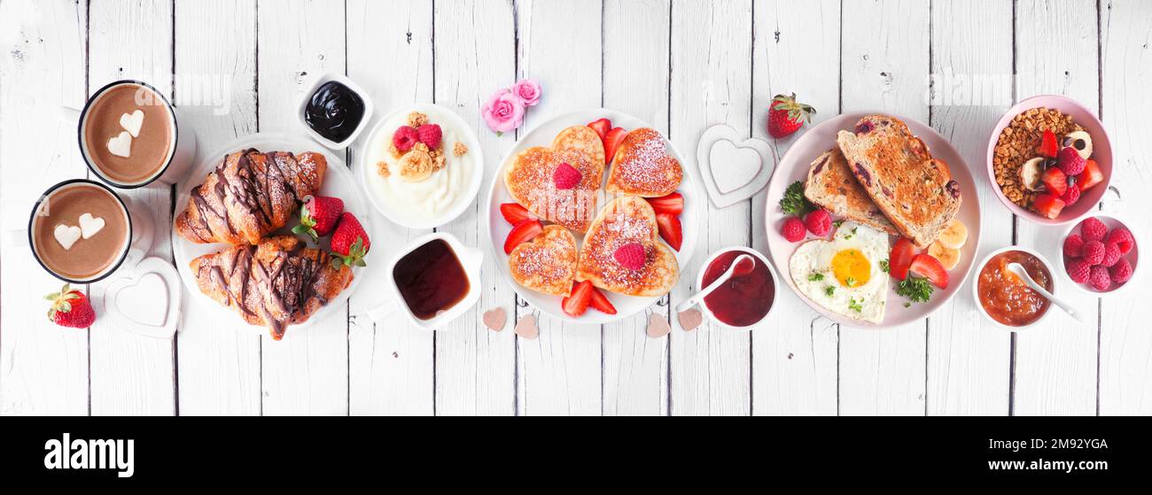 Valentines or Mothers Day breakfast table scene. Above view on a white ...