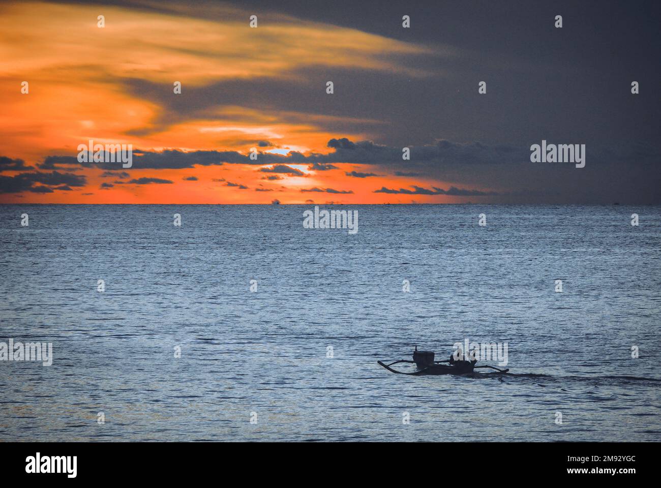 Silhouette of a jukung, a traditional Balinese fishing boat Stock Photo ...