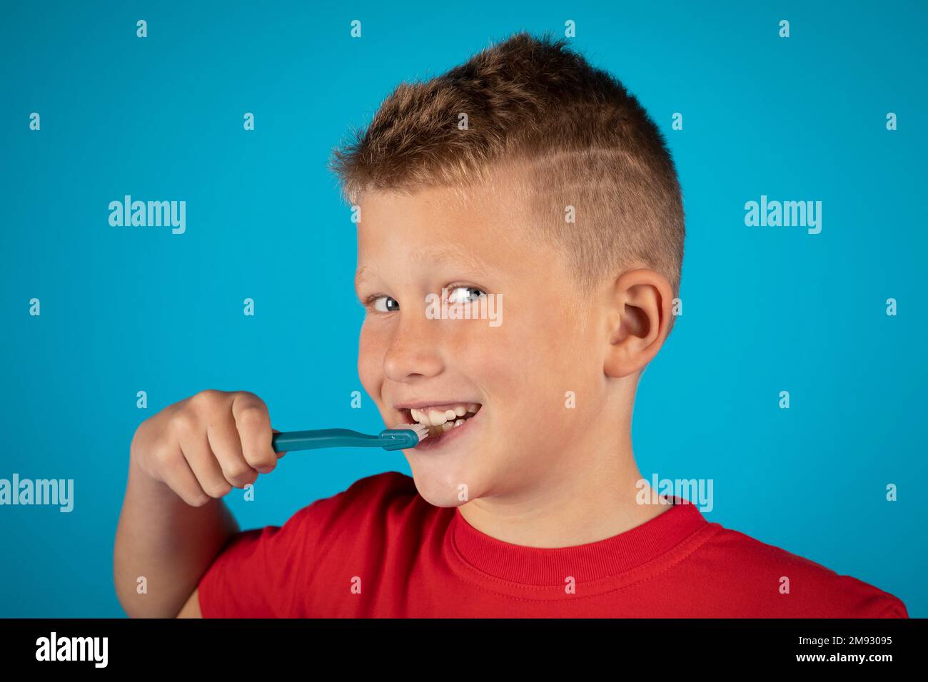 Cute Boy Brushing Teeth With Toothbrush And Looking At Camera Stock ...