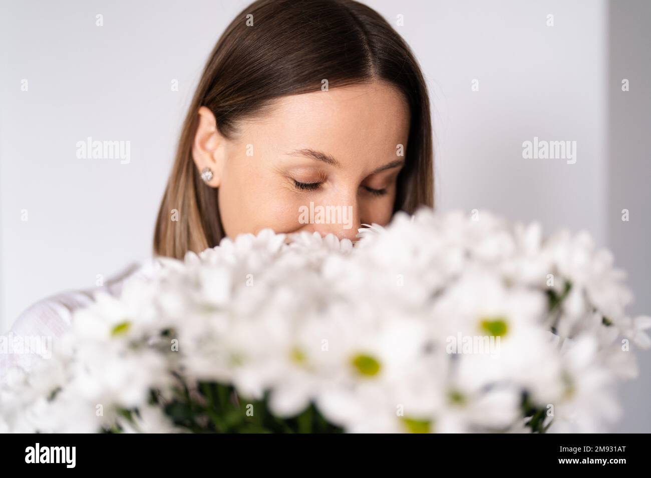 Good looking Caucasian woman smells flowers, she is happy for get a ...