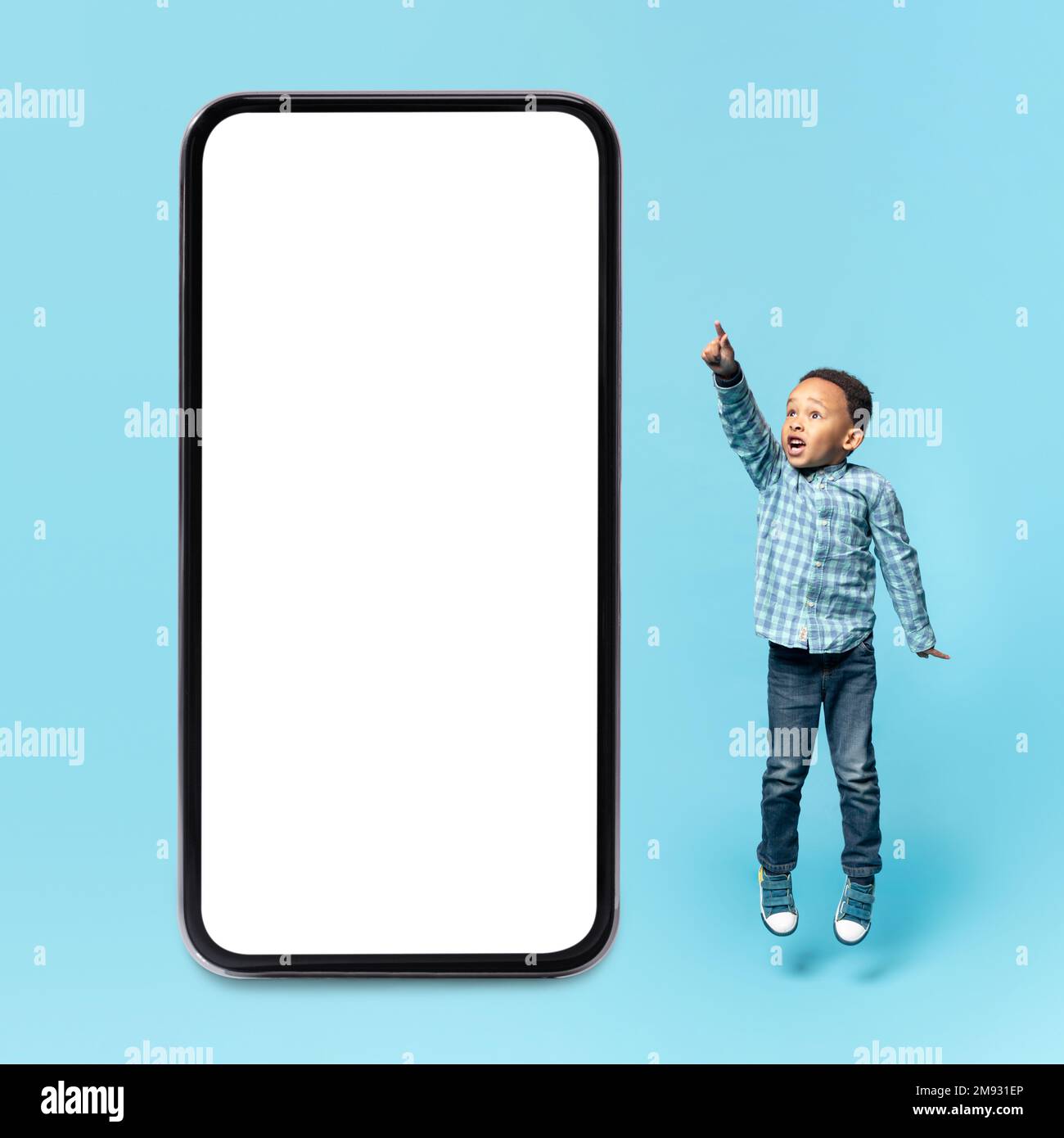 Educational kids mobile app. Surprised black little boy pointing aside ...