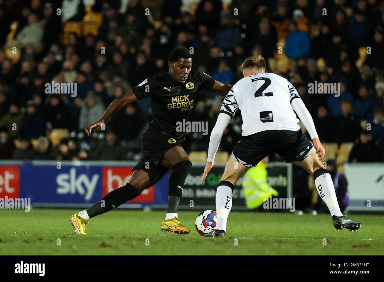 Ephron Mason-Clark of Peterborough United is confronted by Lewis Cass ...
