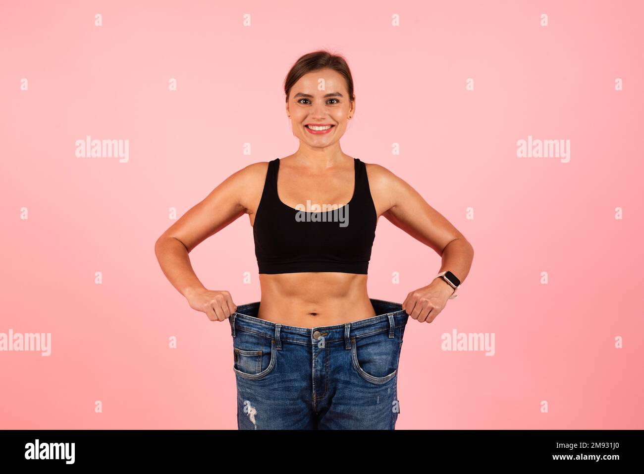 Weight Loss Result. Happy Slim Beautiful Woman Wearing Oversized Jeans ...