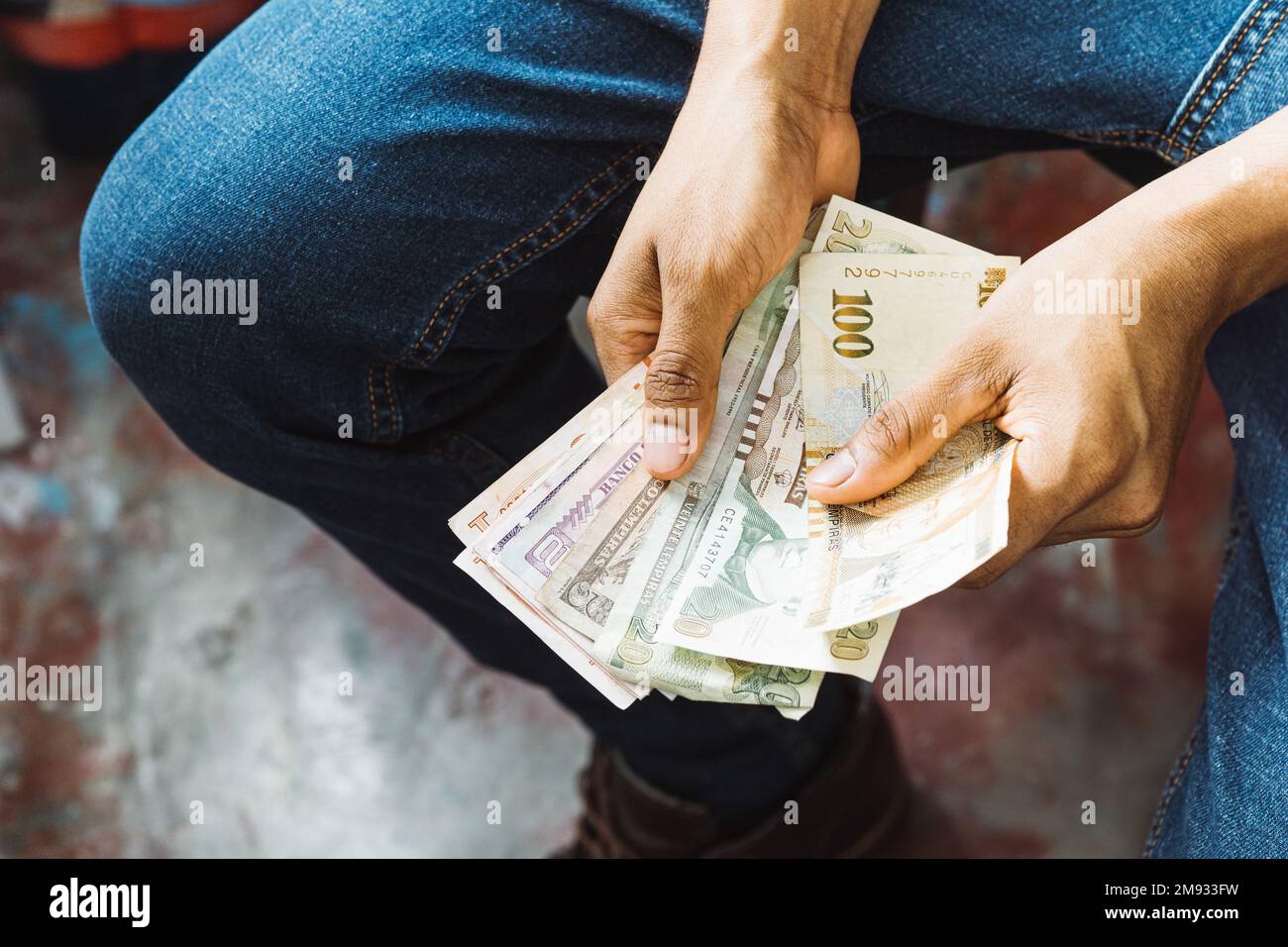 A selective focus of male hands holding Honduran lempira in his hands ...