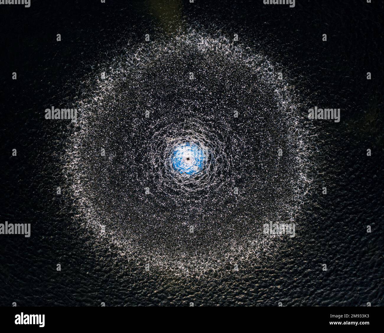 A top view of a fountain surrounded with water drops Stock Photo - Alamy